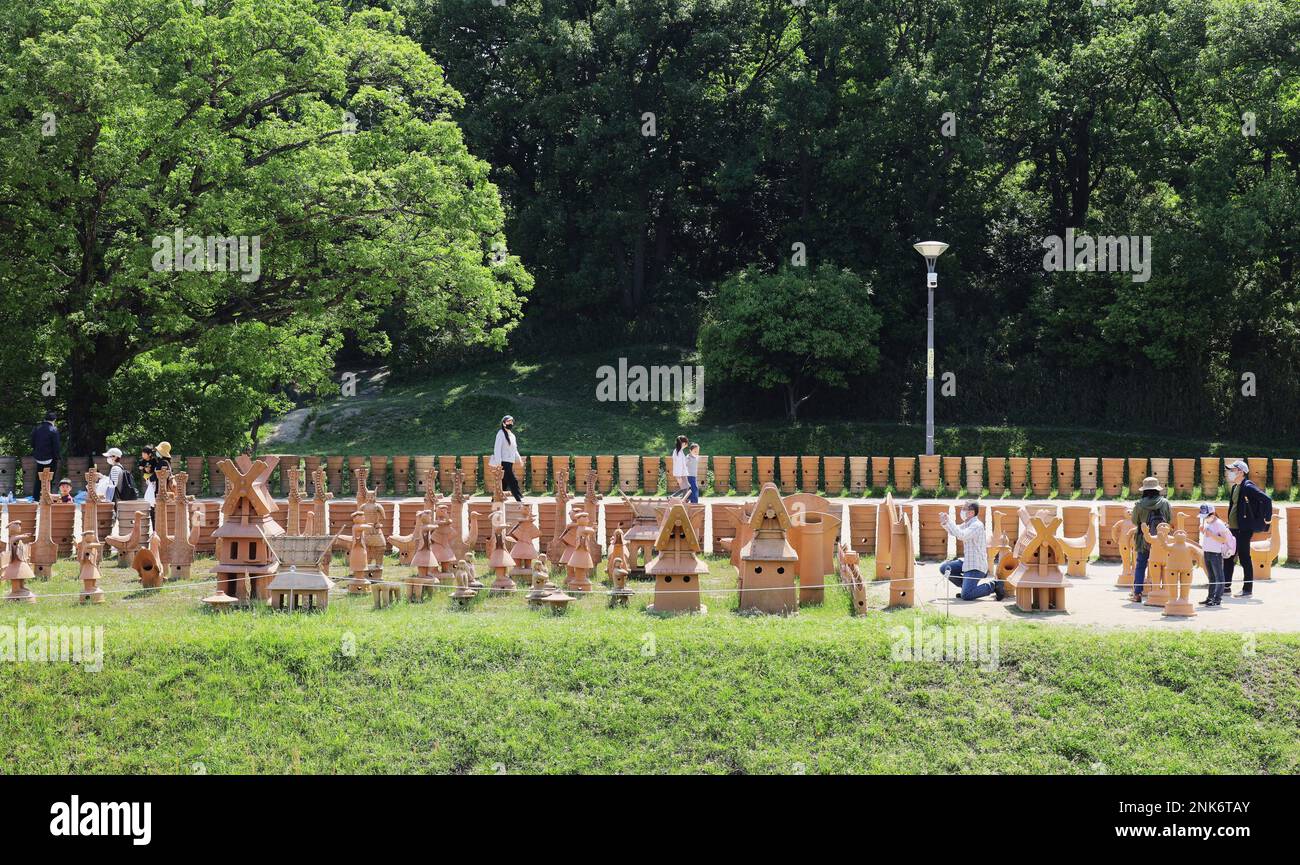 Around 190 haniwa (clay figures) of houses, people and animals line up ...