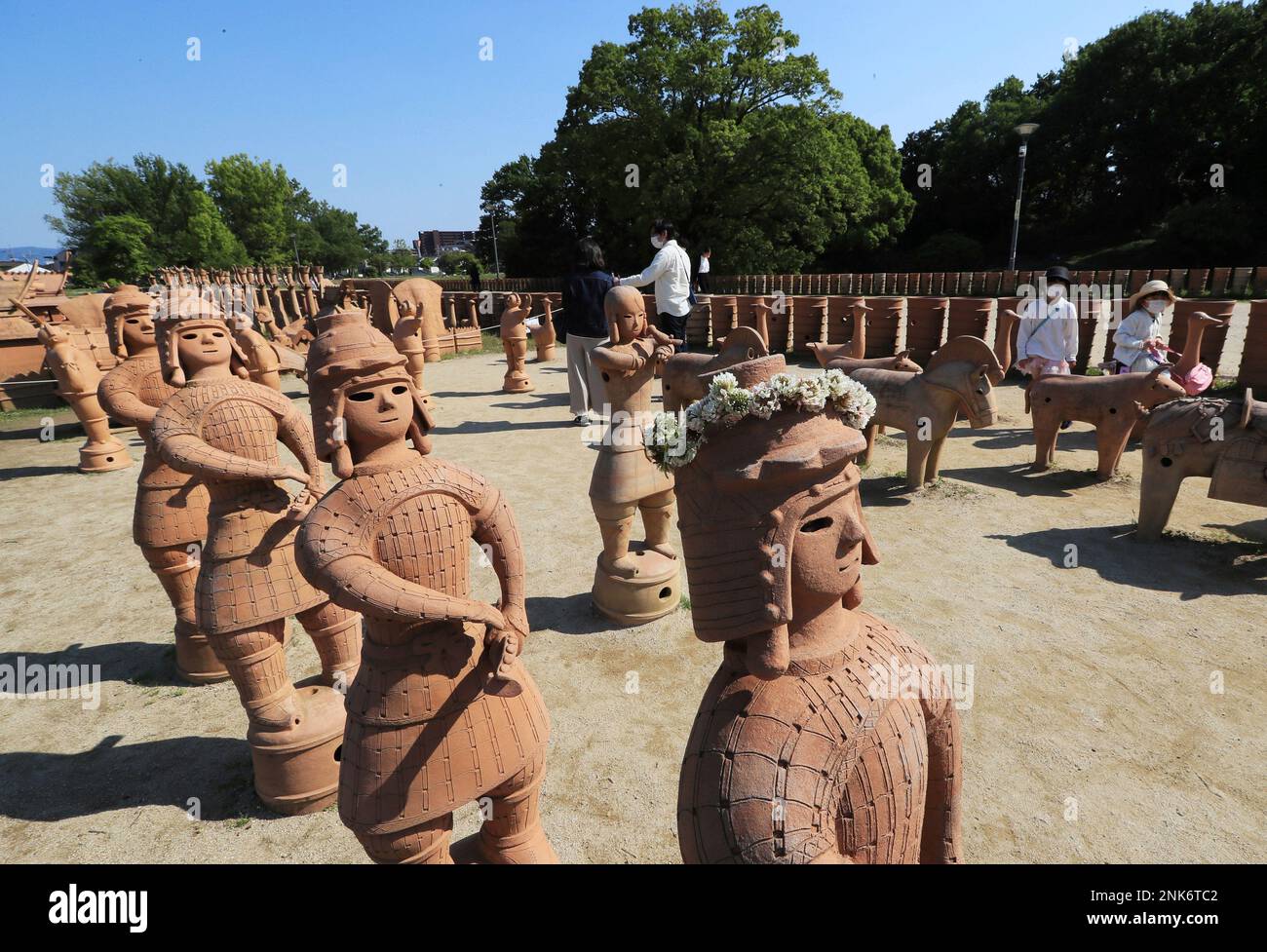 Around 190 haniwa (clay figures) of houses, people and animals line up ...