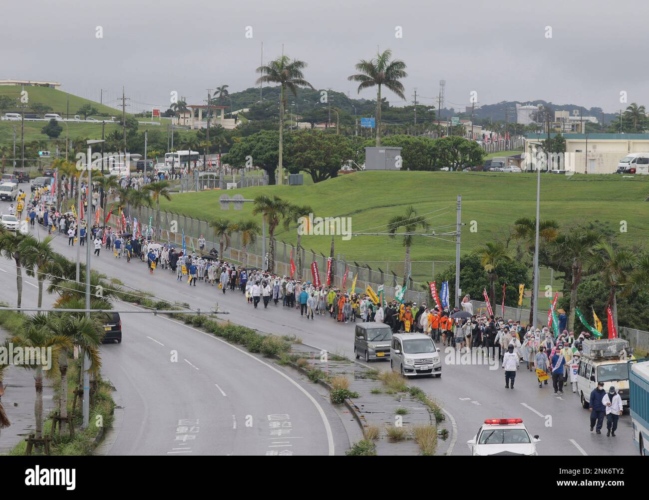 Participants march near U.S. military's Camp Foster, also known as Camp ...