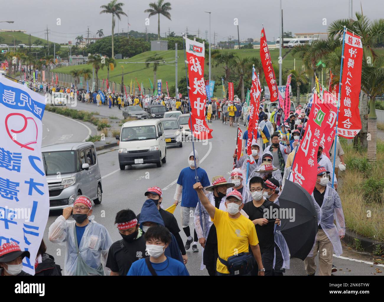 Participants march near U.S. military's Camp Foster, also known as Camp ...