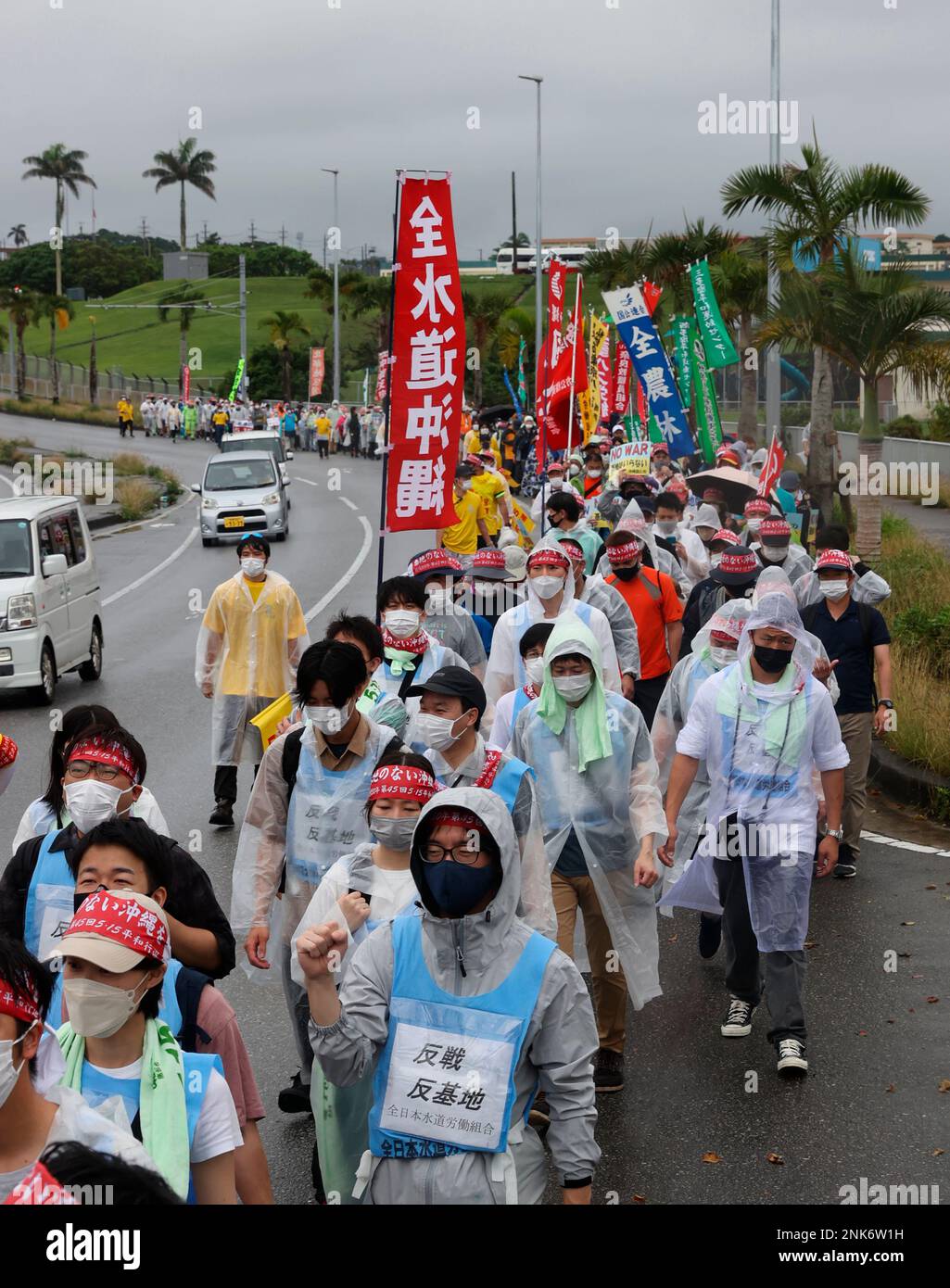 Participants march near U.S. military's Camp Foster, also known as Camp ...
