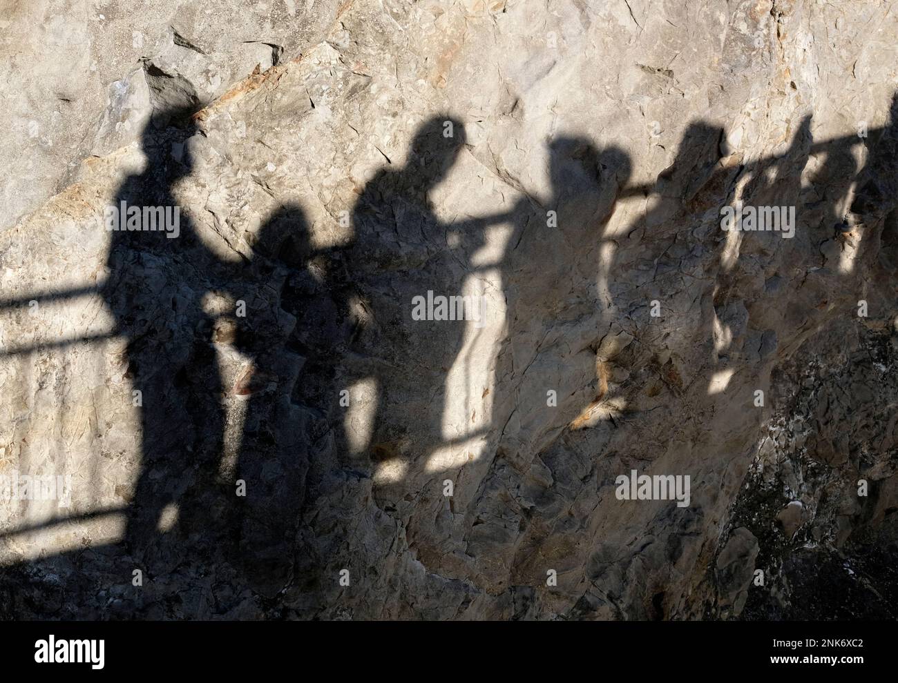 Shadow of a crowd of people on a cliff Stock Photo - Alamy