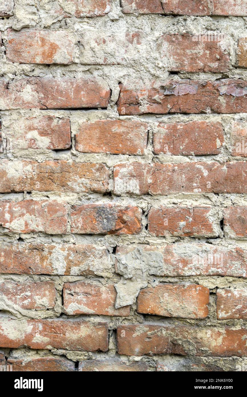 Red uneven brick wall backgroundold. Closeup vertical Stock Photo - Alamy