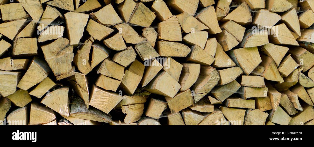 Pile of chopped fire wood logs prepared for winter. Close up ...