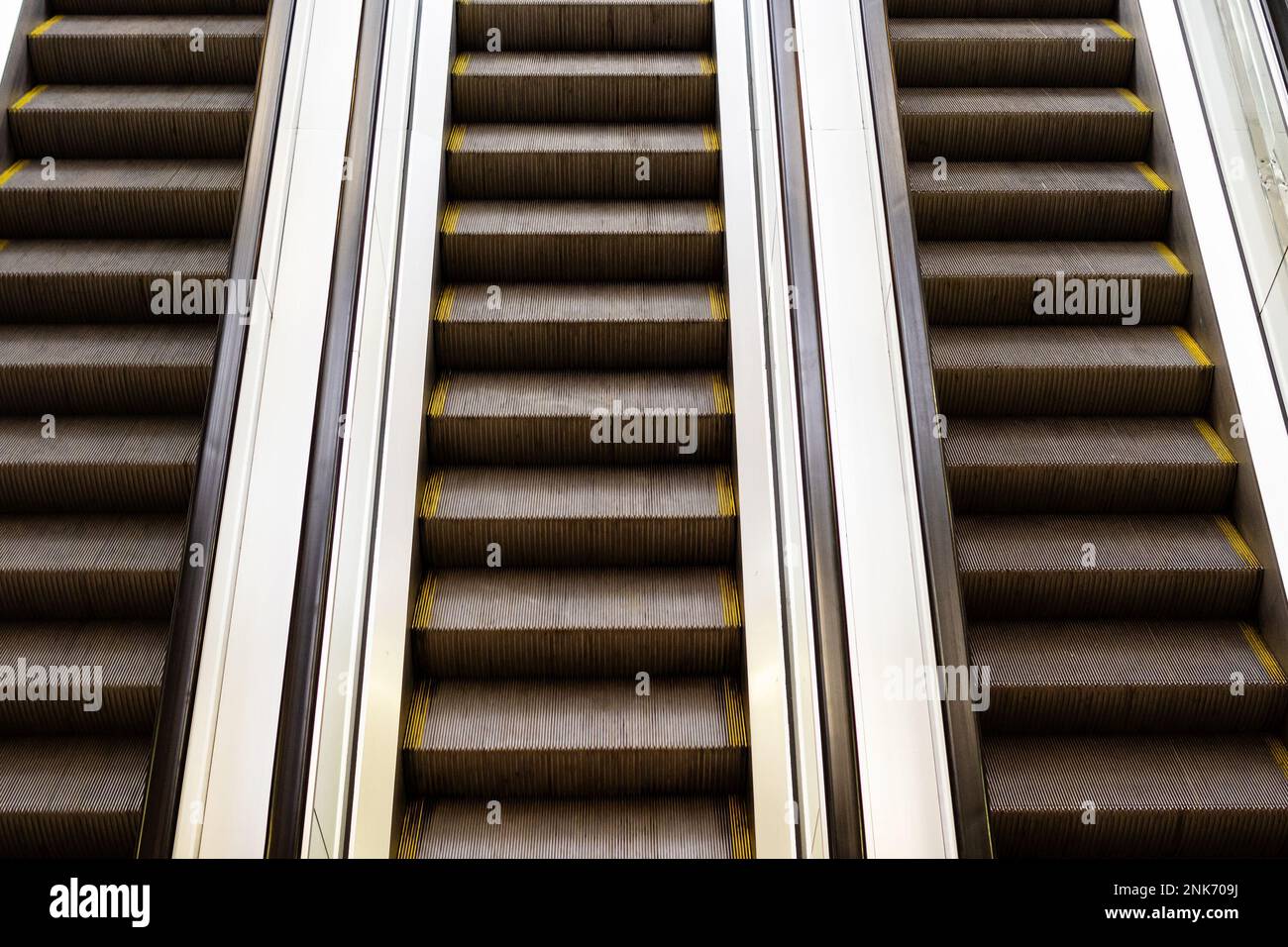 three lane of indoor escalator with moving middle track illumintared by ...
