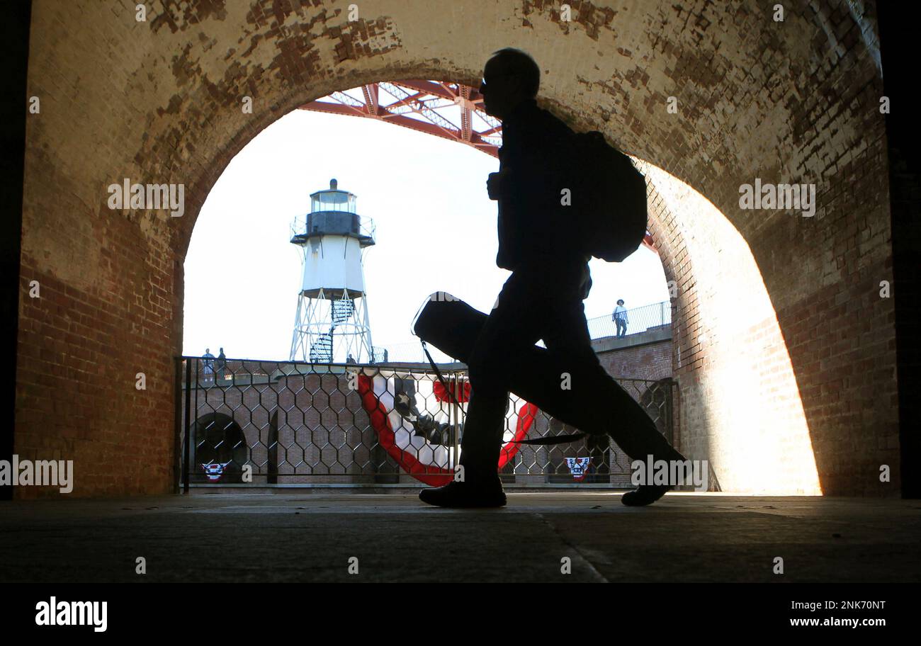 Videographer Doug Hall makes his way through Fort Point after another ...