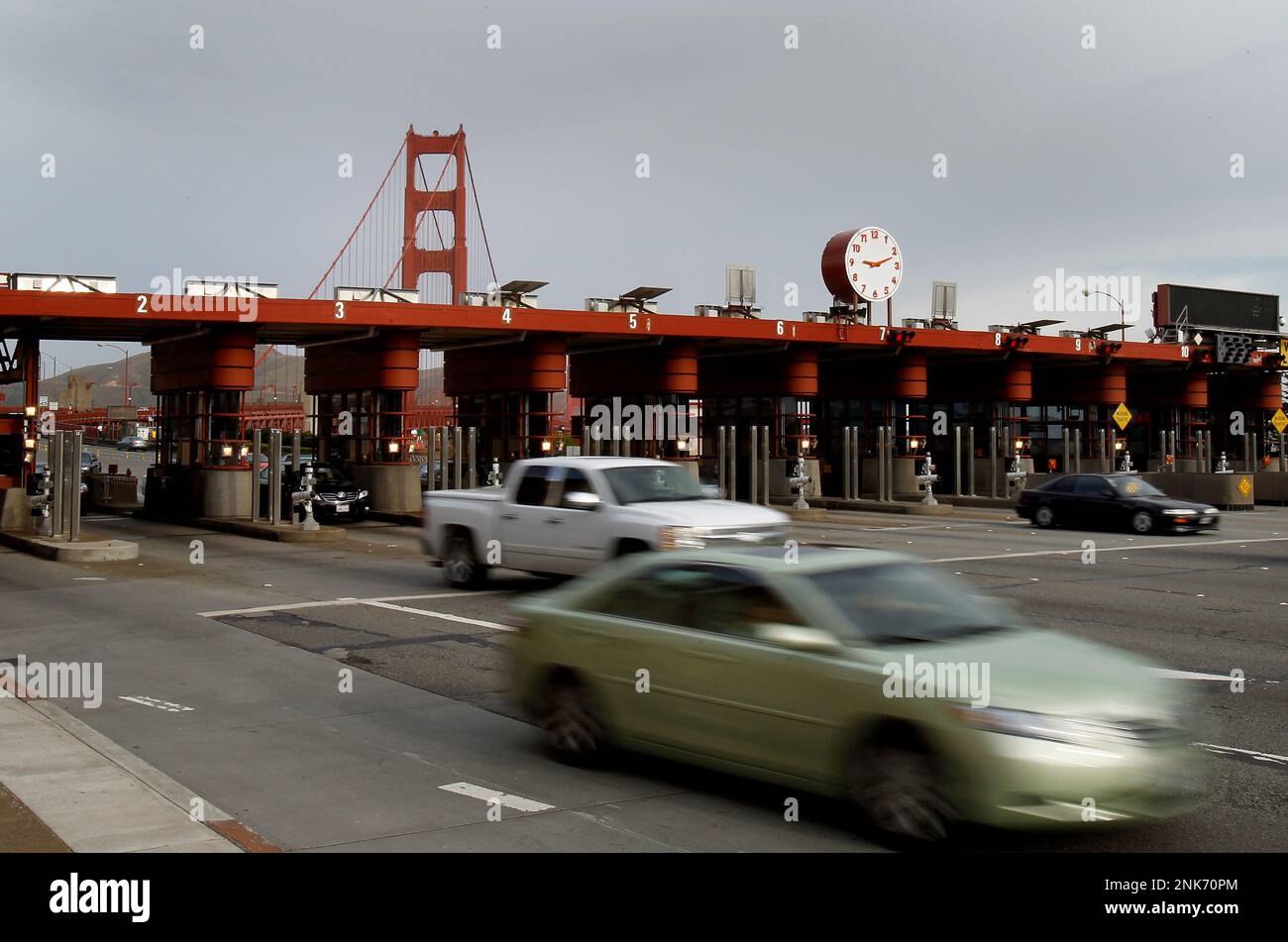 Cars zoom away from the toll plaza at the Golden Gate Bridge, some pay ...