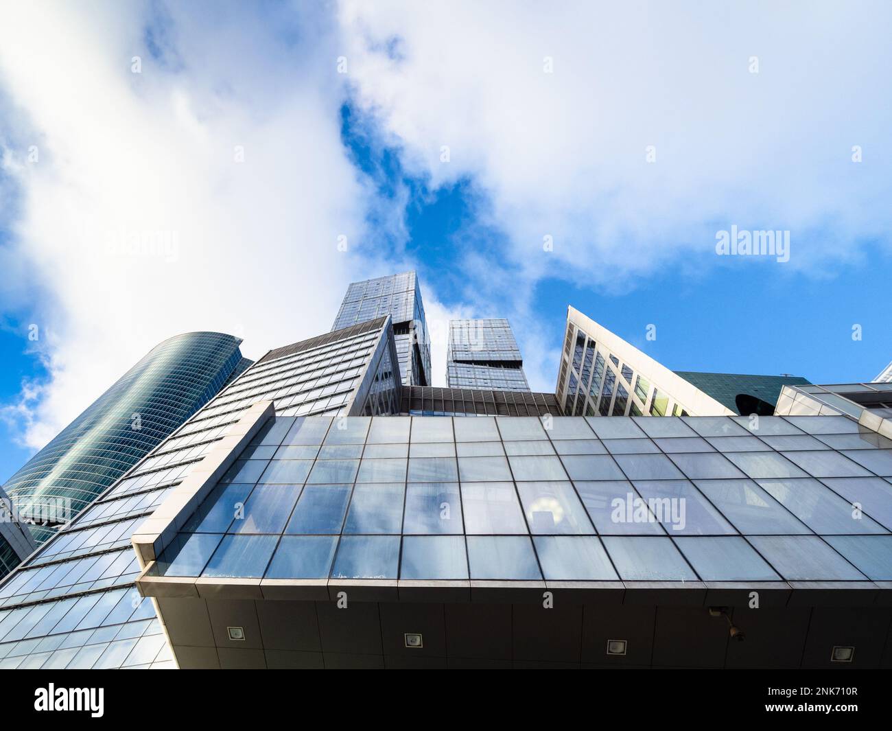 bottom view of glass walls of skyscrapers on cloudy day in Moscow city ...