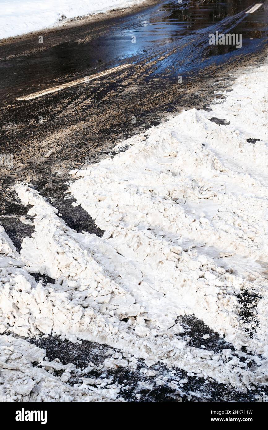 snow slush and wet from melting snow surface of urban asphalt road ...