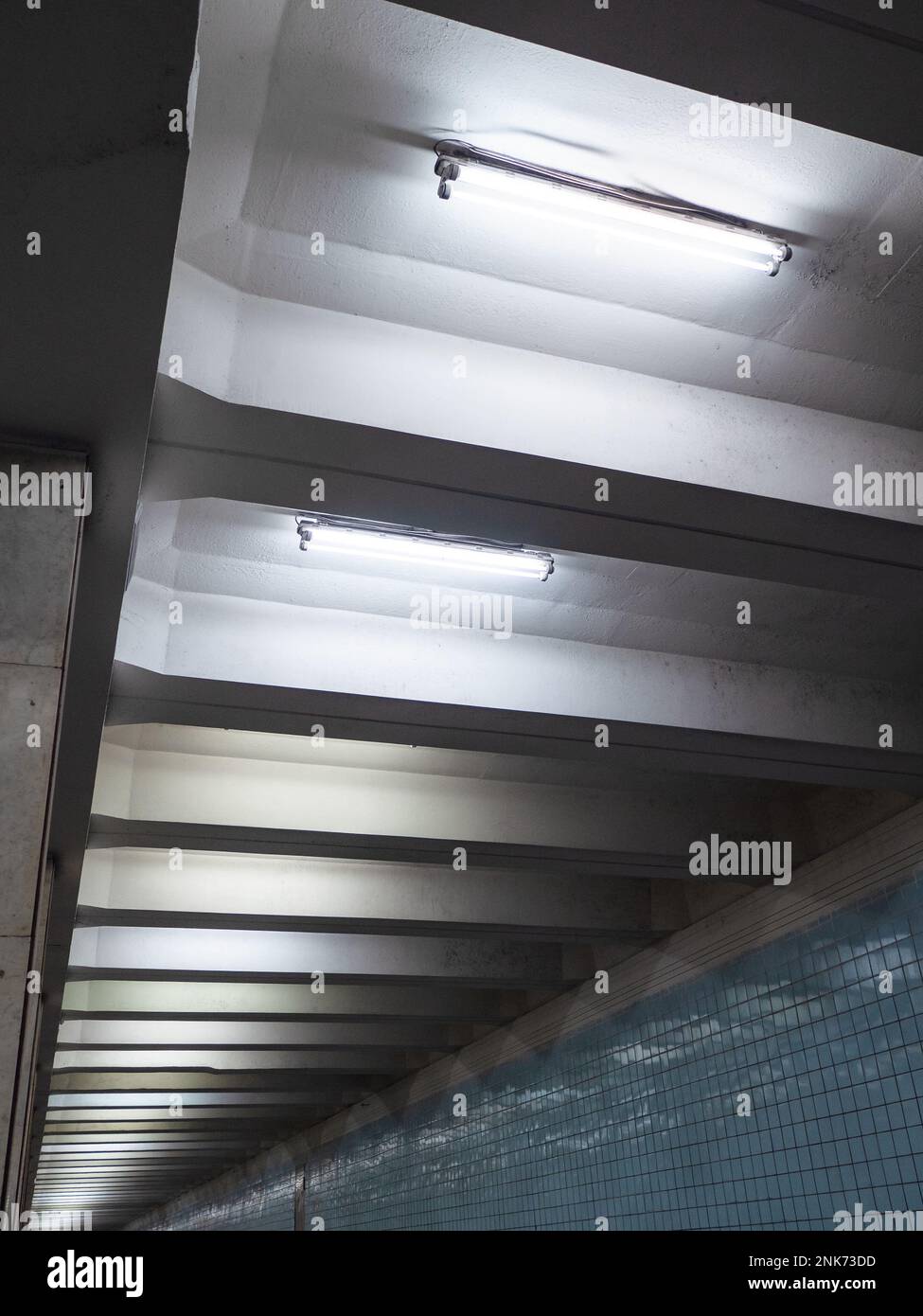fluorescent lamps on ceiling above railway tracks in subway Stock Photo ...