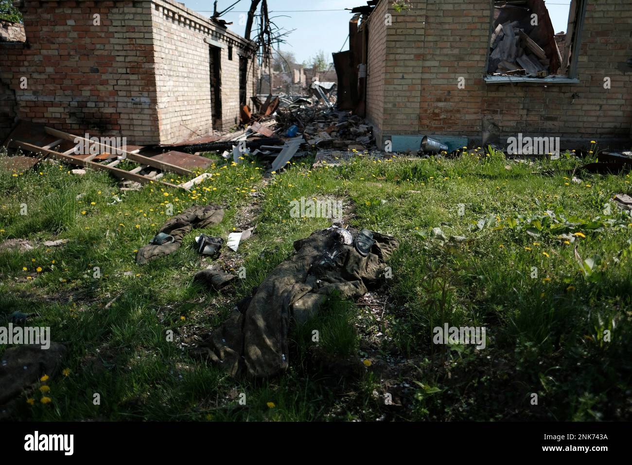 Clothes, binoculars and others are scattered at a garden in Bucha, Kyiv ...
