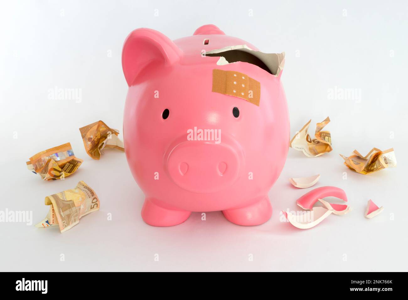Piggy bank symbol for inflation, economy and crisis. Pink coloured on ...