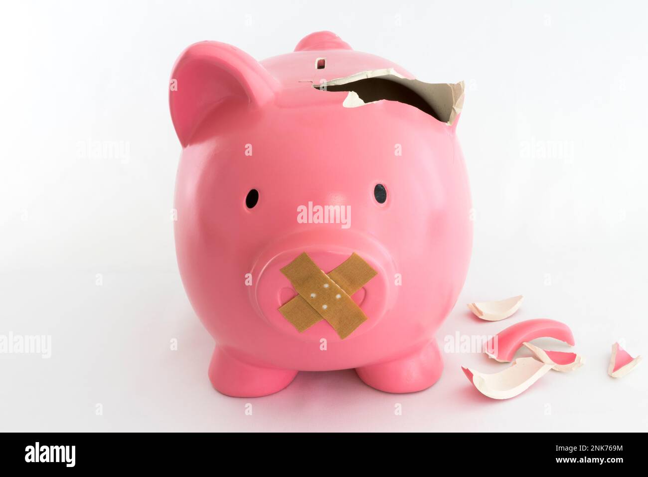 Piggy bank symbol for inflation, economy and crisis. Pink coloured on ...