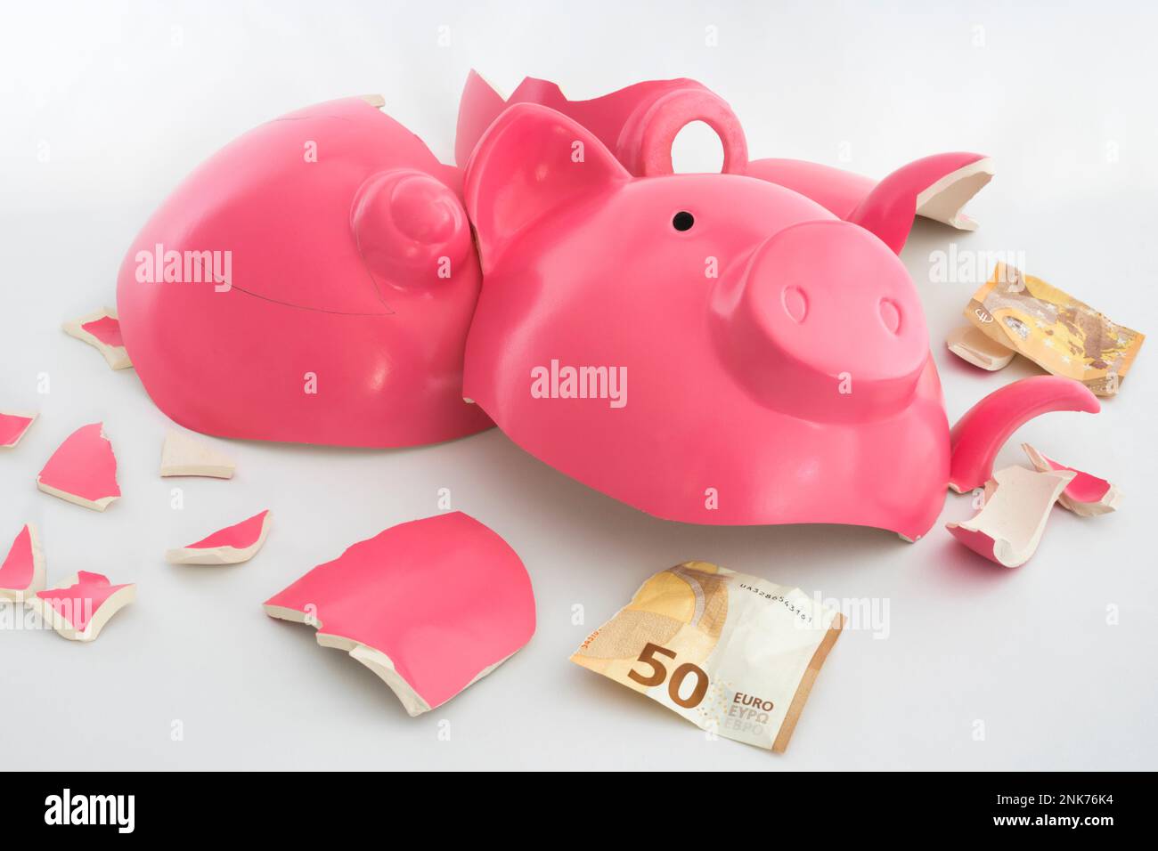 Piggy bank symbol for inflation, economy and crisis. Pink coloured on ...