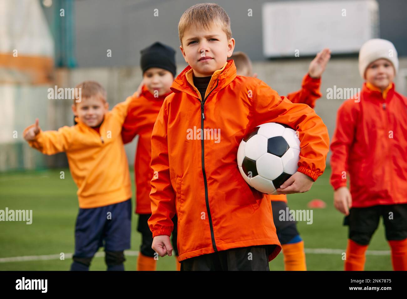 Group of boys, children, football players in uniform standing in a line ...
