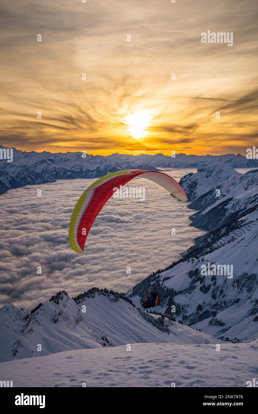 Paraglider taking off into the sunset on the Brienzer Rothorn in ...