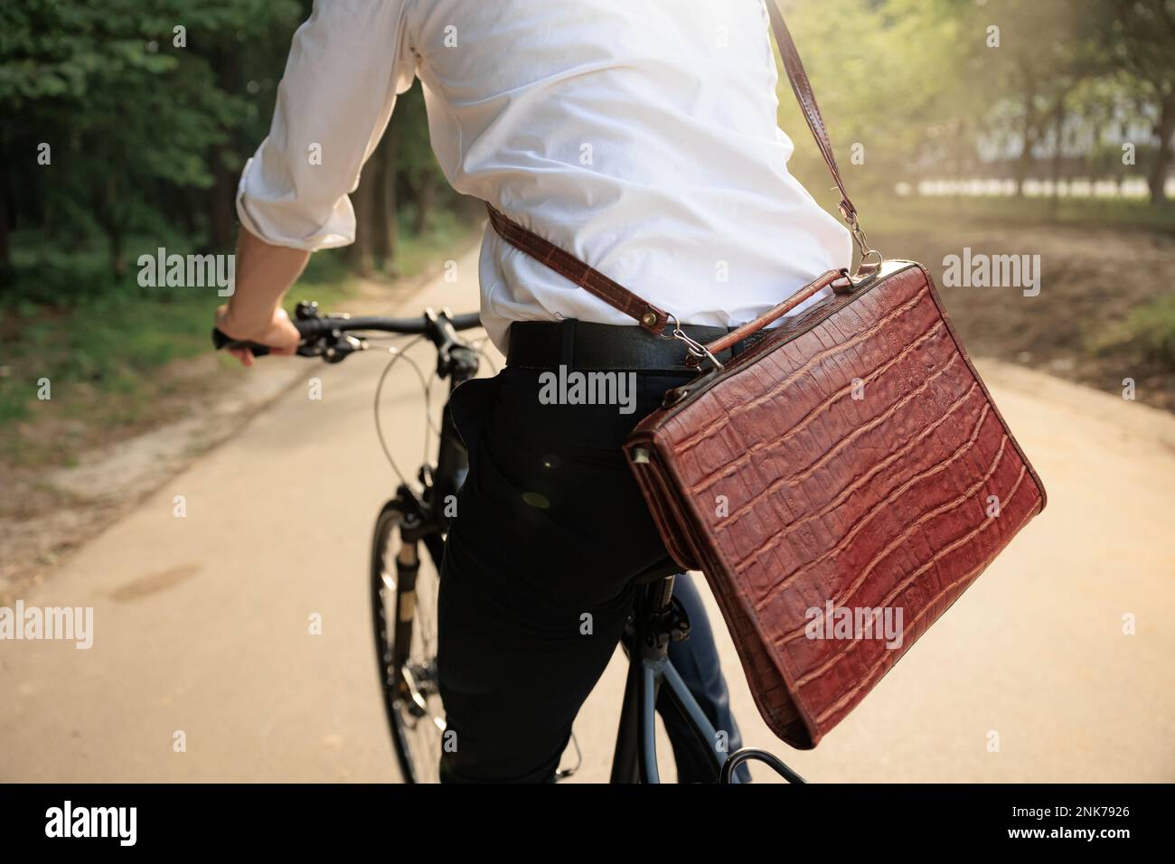 Crop view of anonymous office clerk, wearing white shirt and brown ...