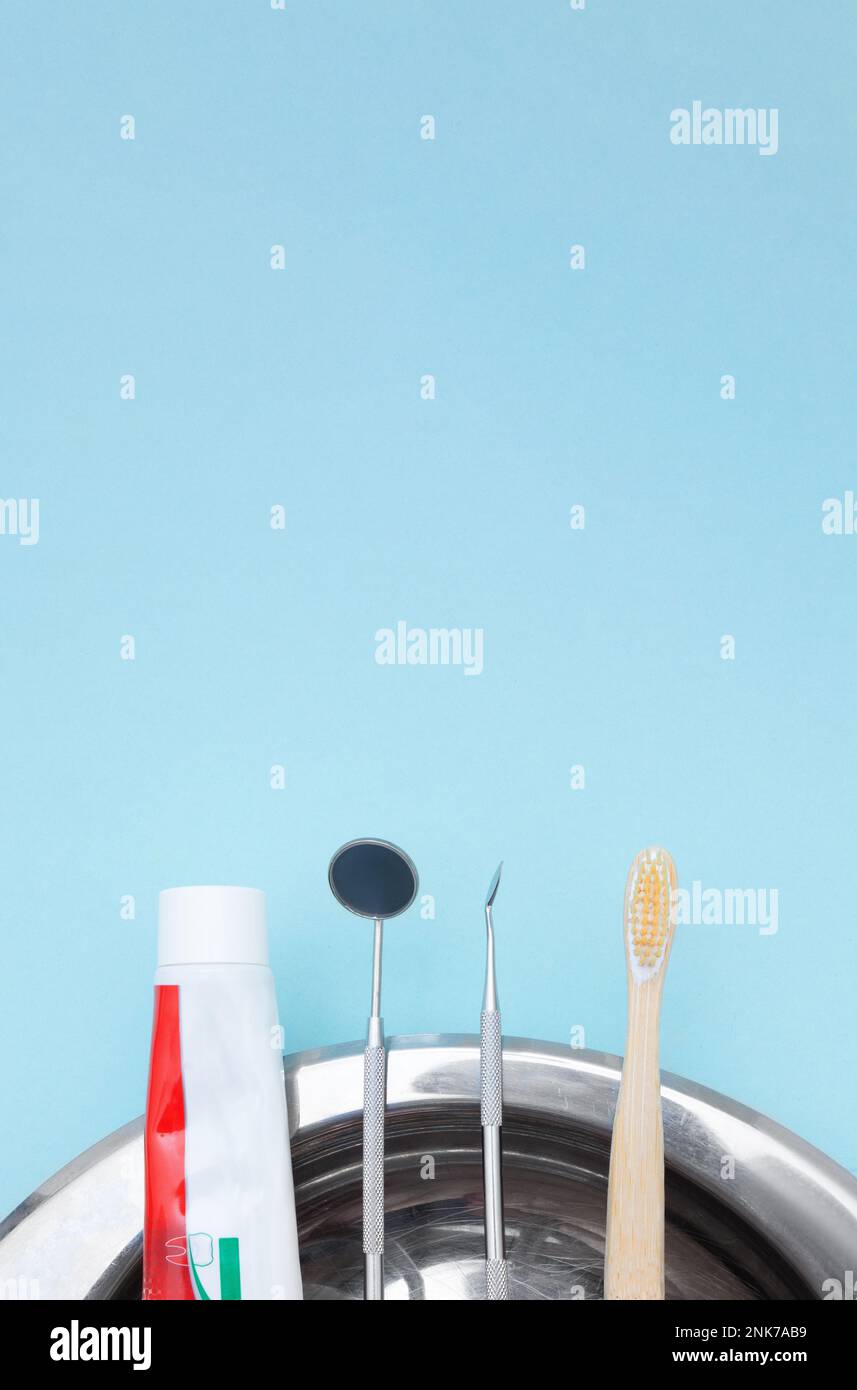 Different tools for dental care, toothbrush and toothpaste on blue ...