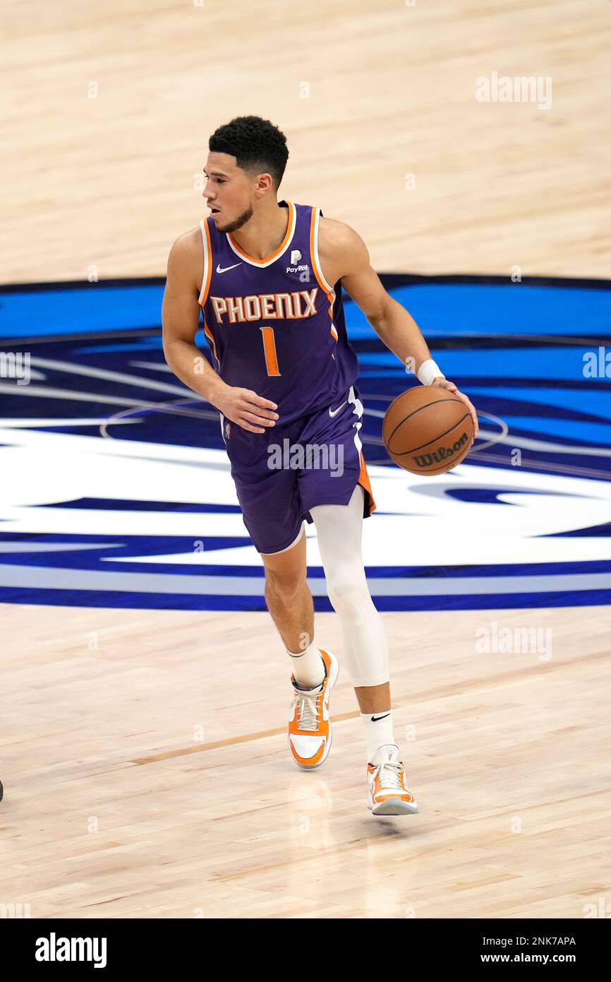 Phoenix Suns guard Devin Booker (1) brings the ball up court during Game 3 of an NBA basketball ...