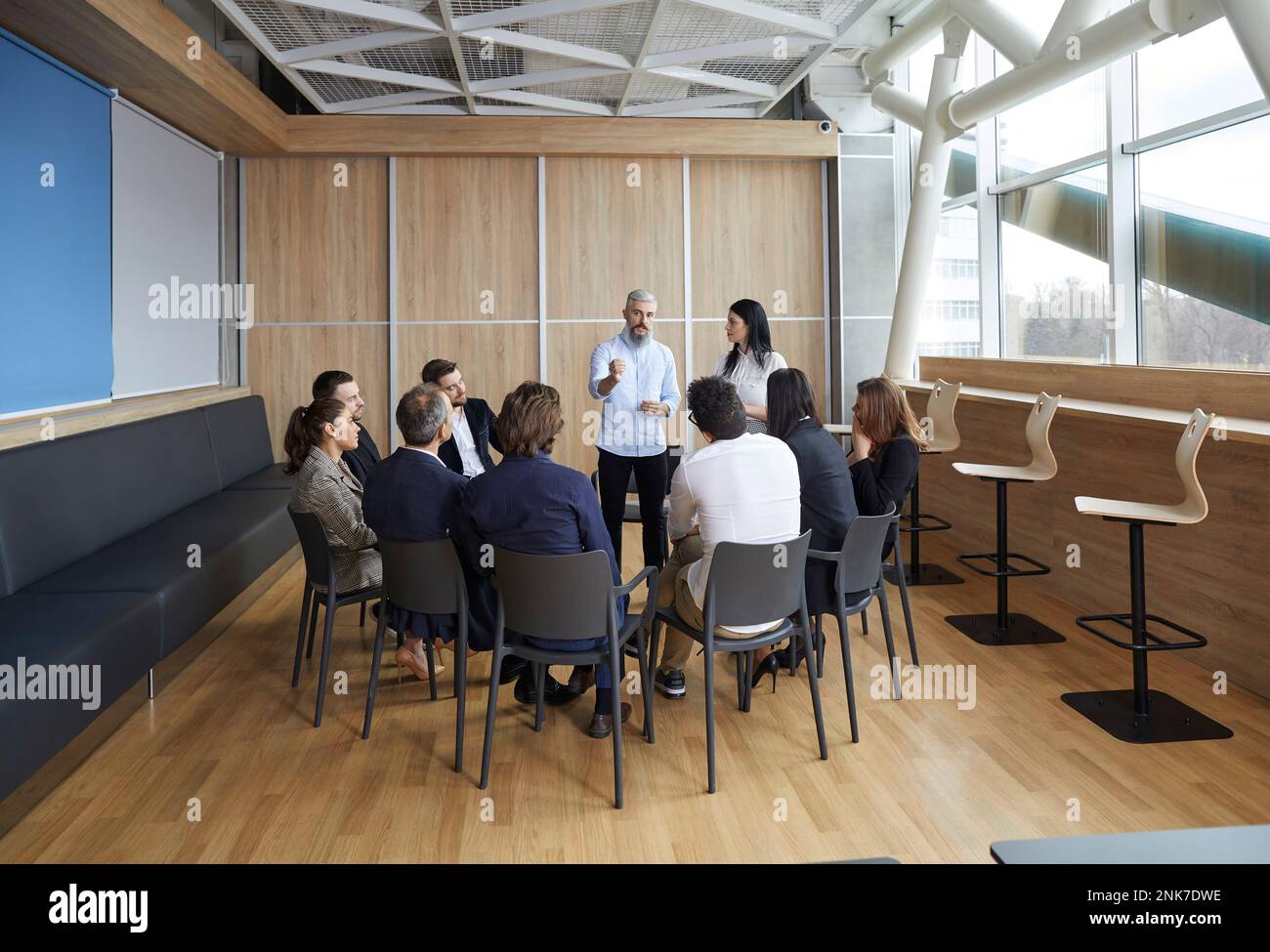 Business trainers old man and young woman conduct training in office ...