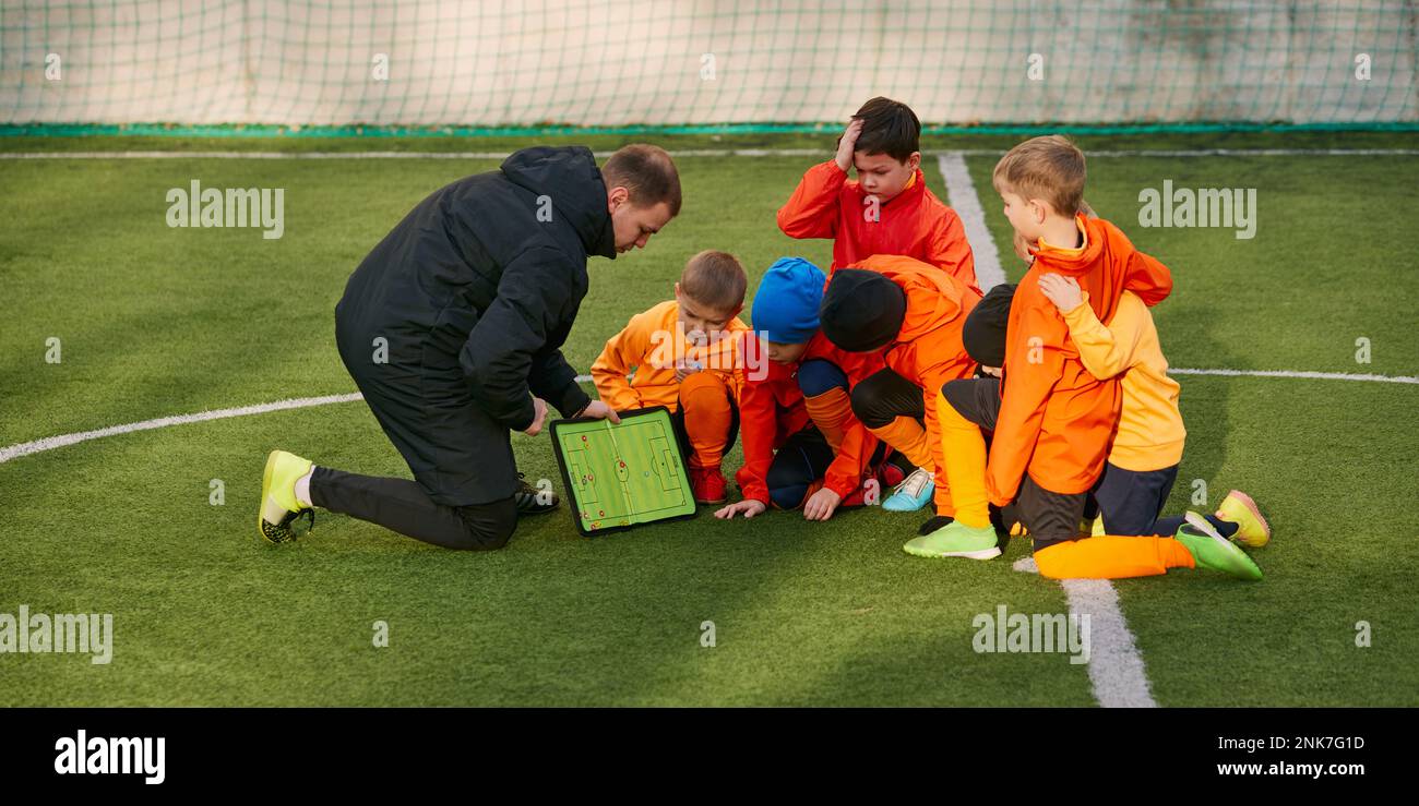 Group of boys, children training football with professional coach on ...