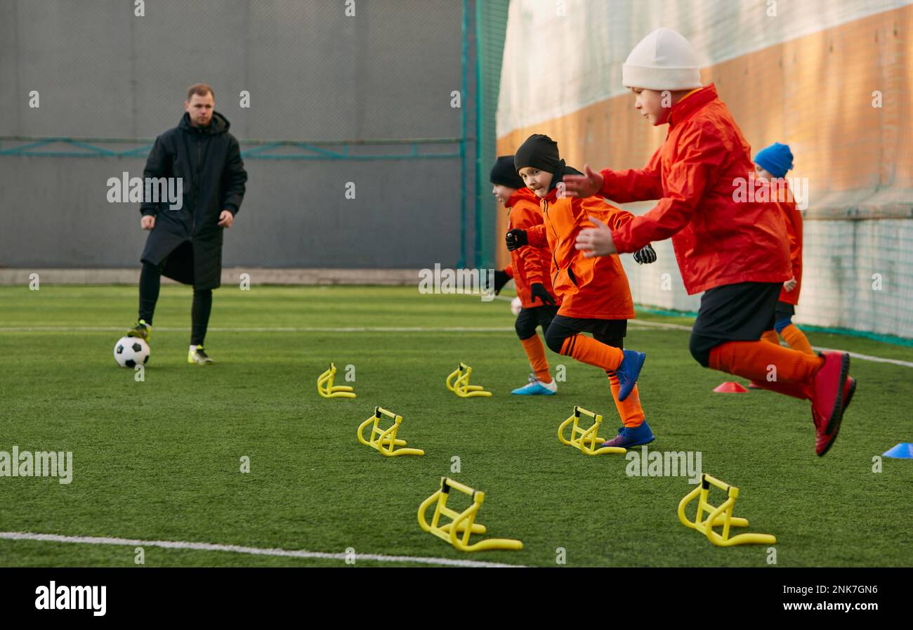 Fast movements. Boys, children, football players doing exercises ...