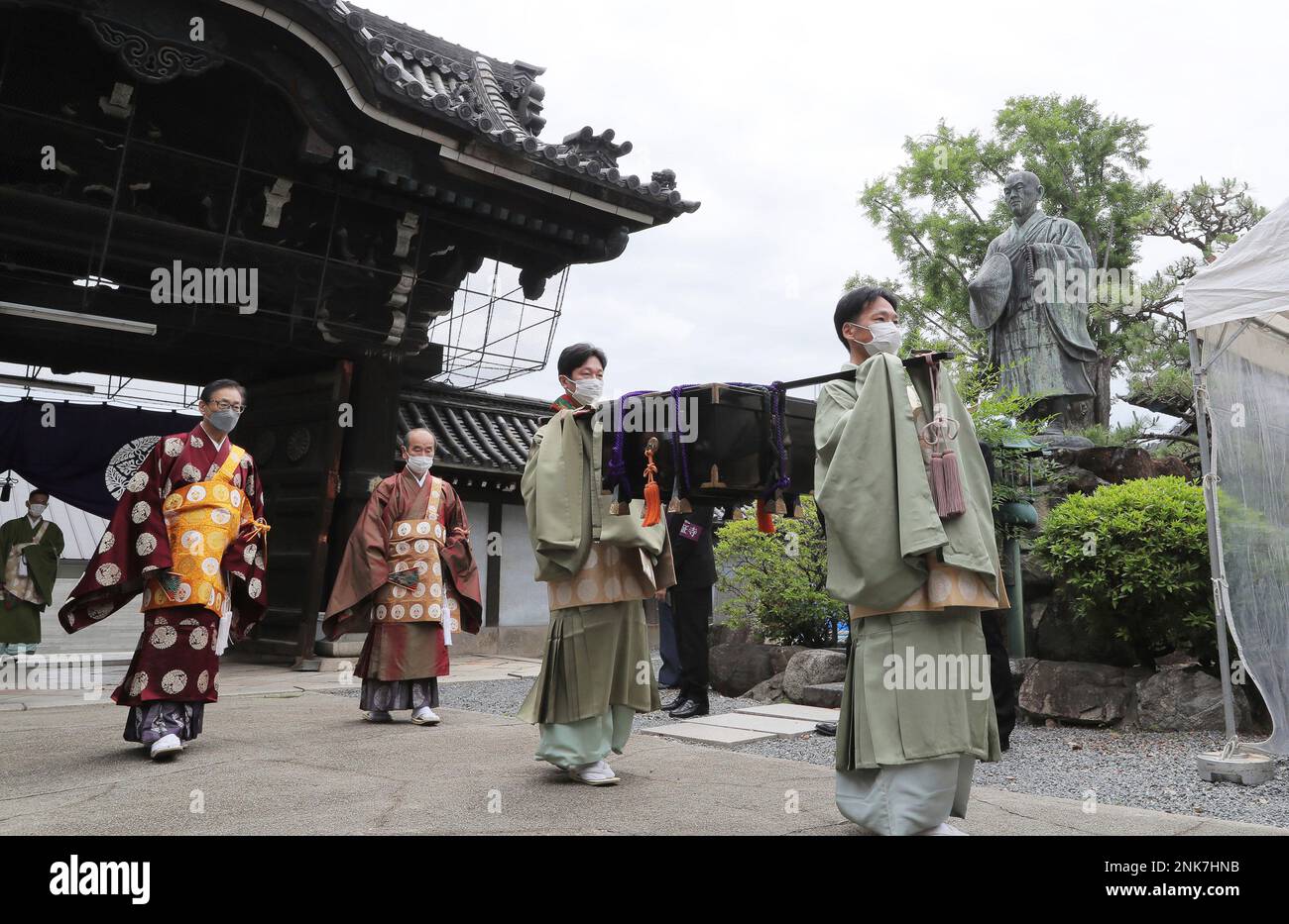 Buddhist monks of the Jodo Shinshu sect carry a karato box containing ...