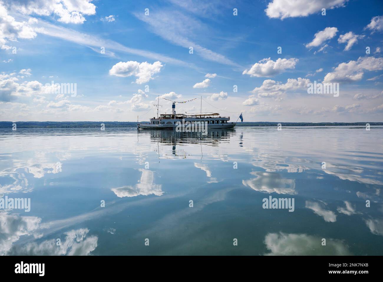 An excursion boat sails over the smooth waters of the Ammersee (Lake ...