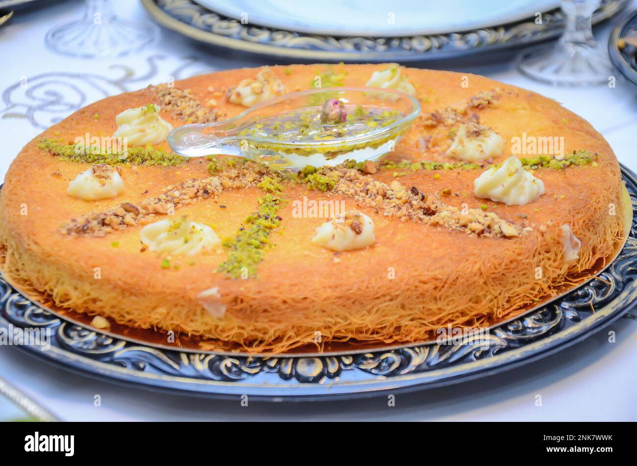 Eastern dessert kunafa in a big dish Top view. Arabic cheese kunafa on ...