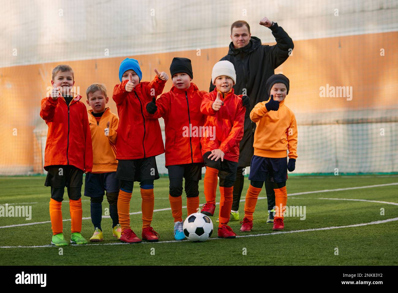 Group of boys, children, football players in uniform standing in a line ...