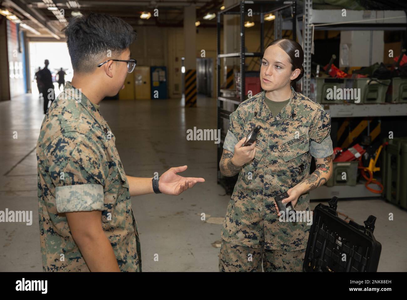 U.S. Marine Corps Cpl. Esther M. Wood, right, trains Cpl. Daniel Tong ...
