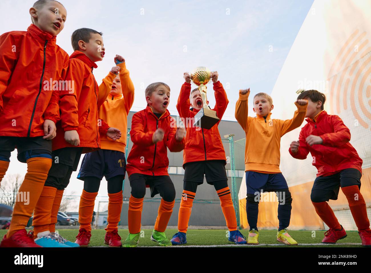 Winning emotions. Group of little boys, children in uniform, football ...