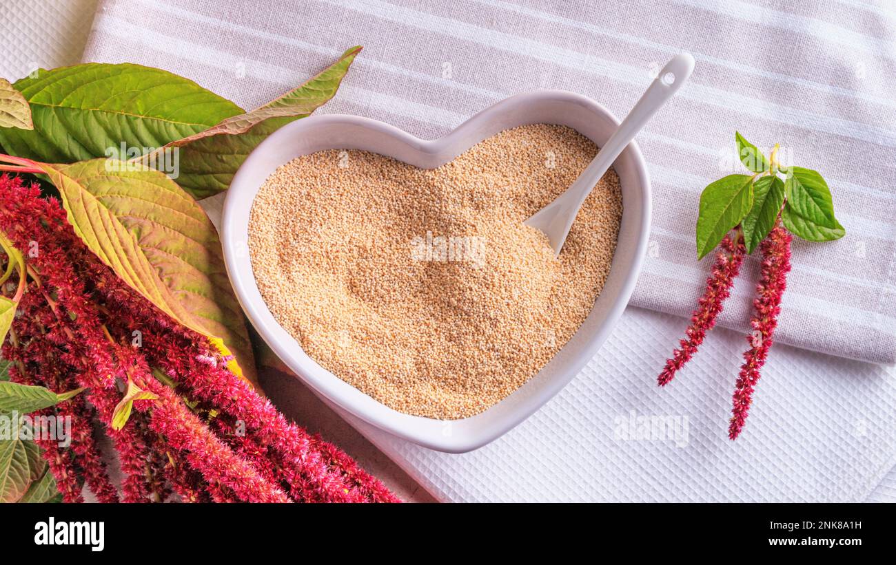 Amaranth grits in a faience white plate in the form of heart with ...