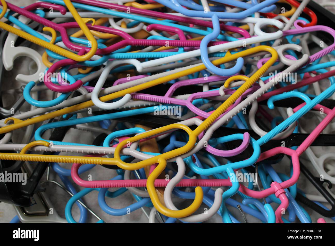 colored clothes hangers made of plastic Stock Photo - Alamy