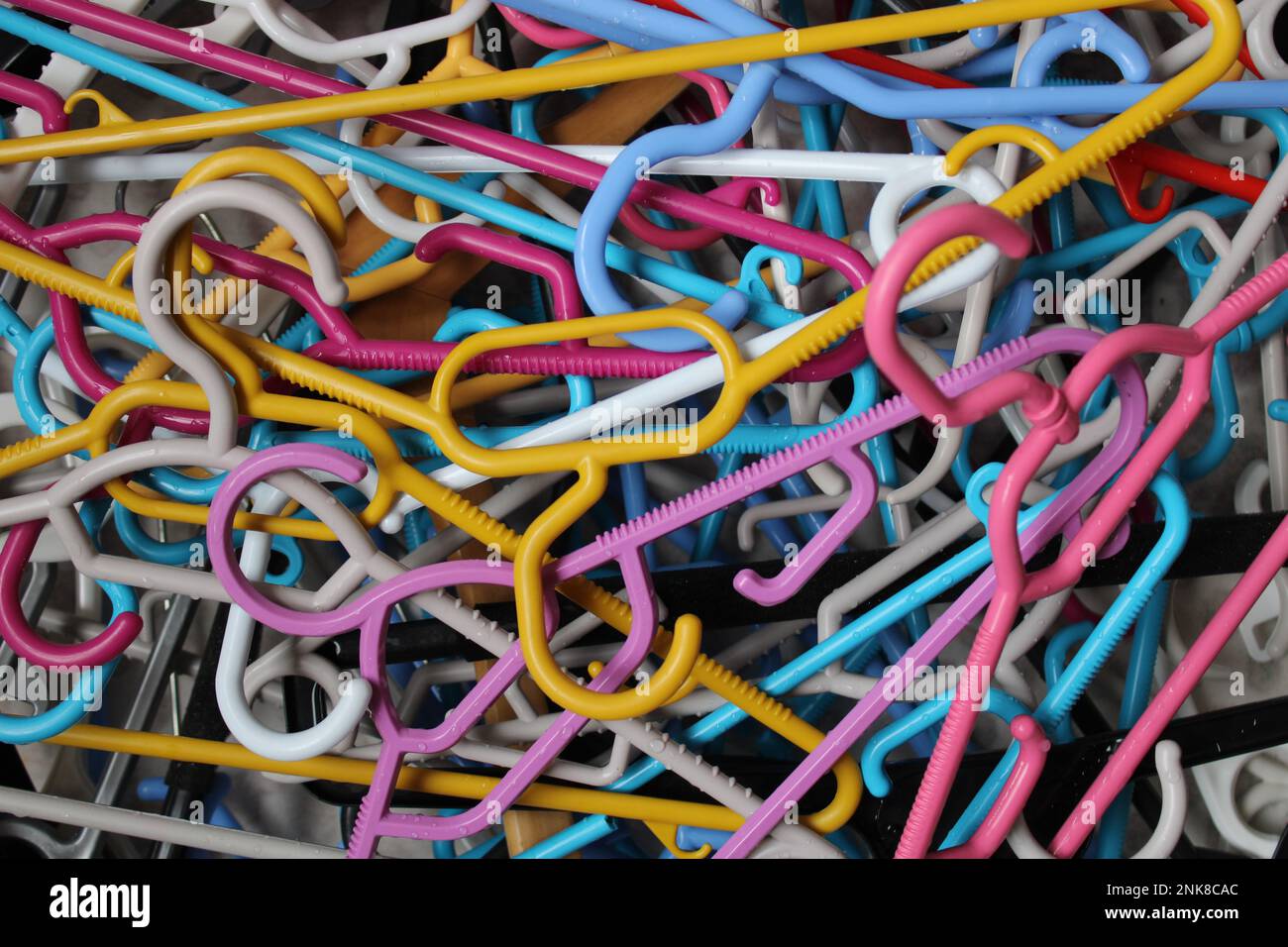 colored clothes hangers made of plastic Stock Photo - Alamy