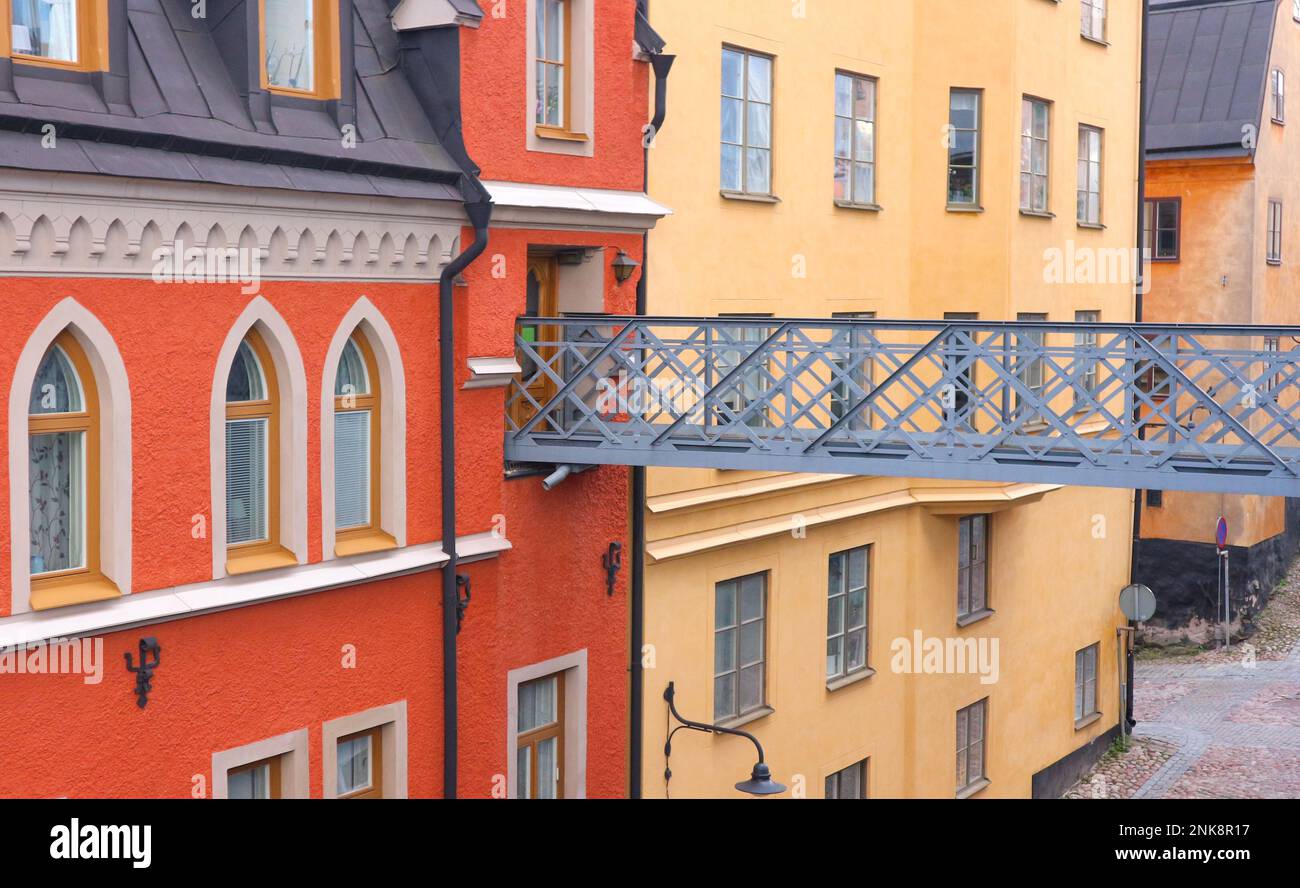 Small bridge between buildings in a city Stock Photo - Alamy