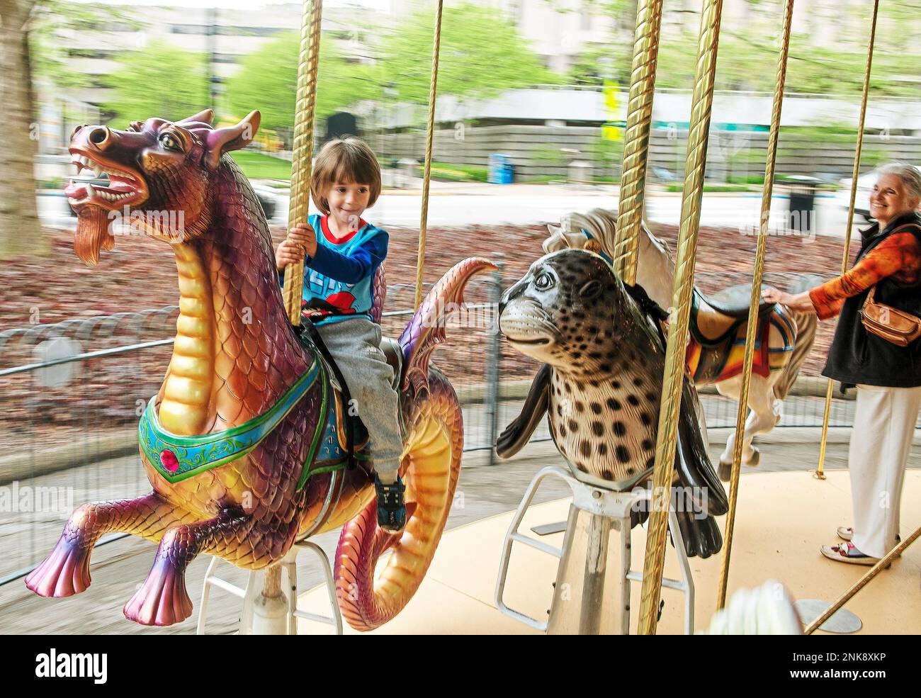 Zavier Zinn, 3, of Fox Chapel, Pa. rides the PNC Carousel with twin ...