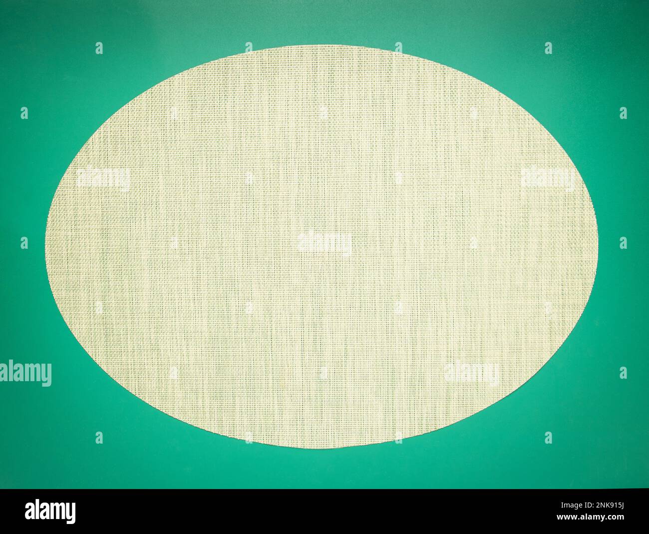 Mocap, oval vignette of a textured gray-green fabric on a dark green ...