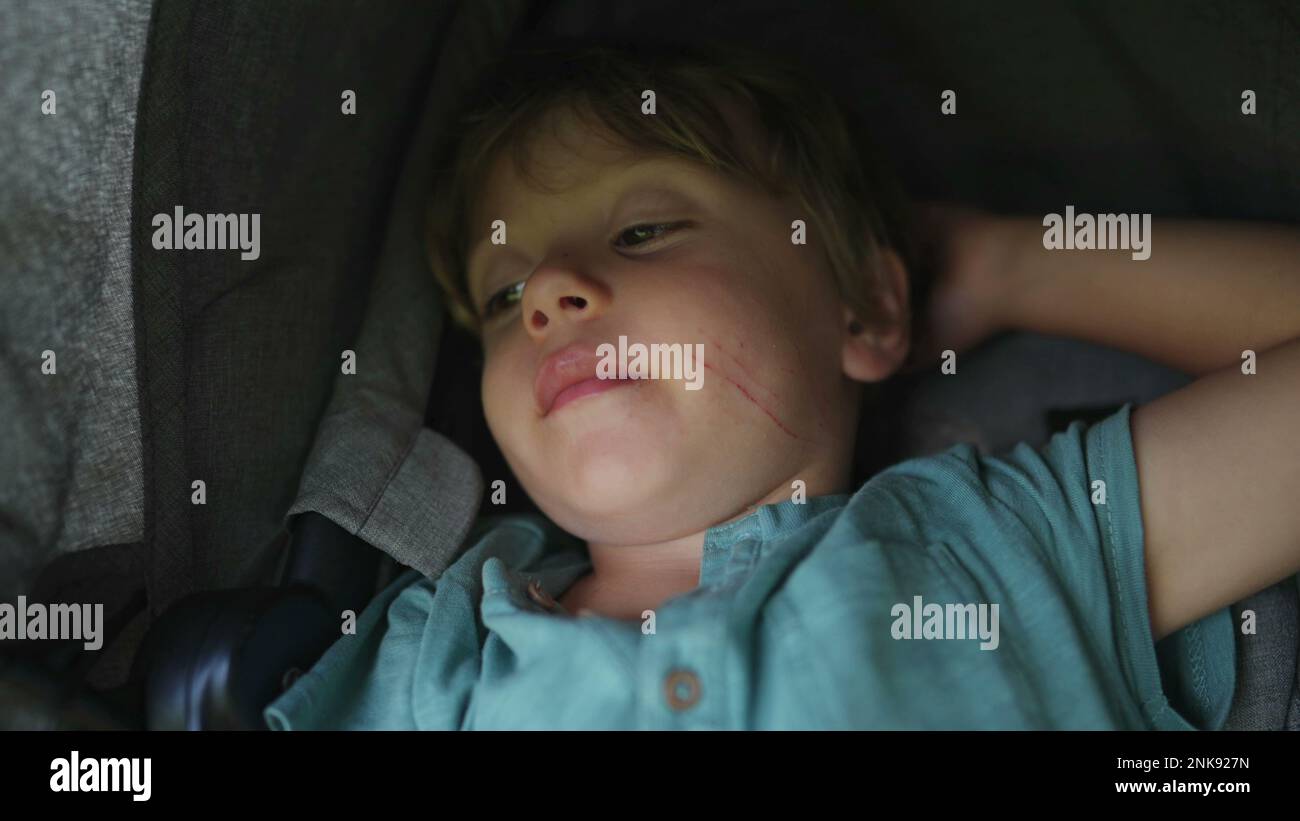 One small boy sitting inside stroller waking up from nap Stock Photo ...