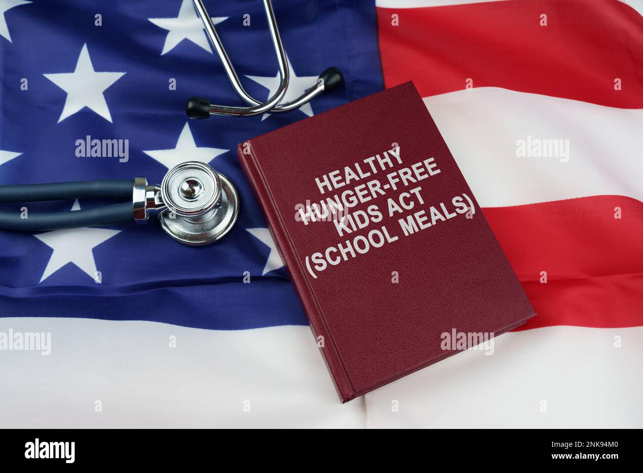 Law concept. On the US flag lies a stethoscope and a book with the inscription - HEALTHY HUNGER ...