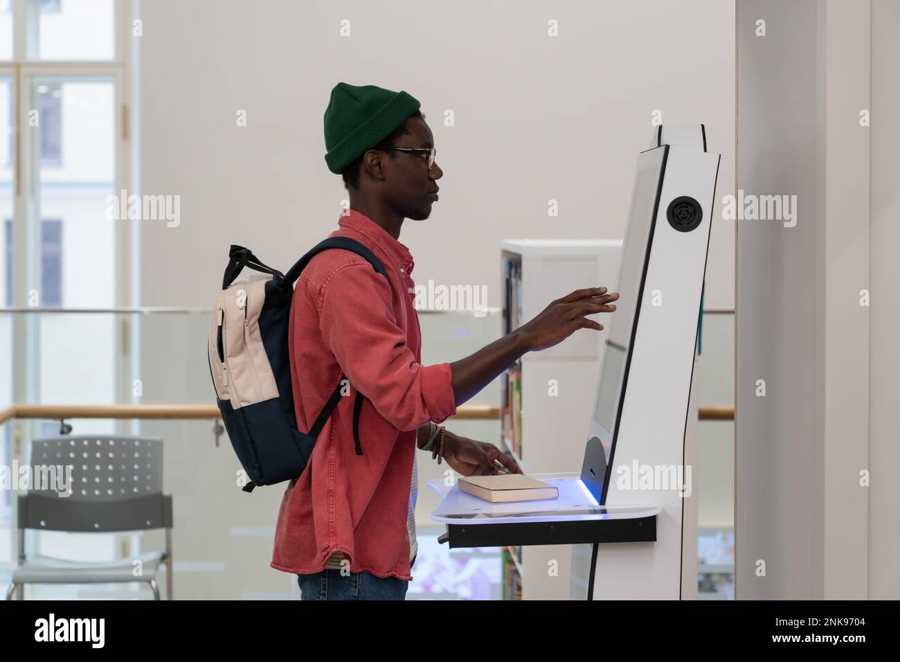 Concentrated African American man student stands near terminal to check ...
