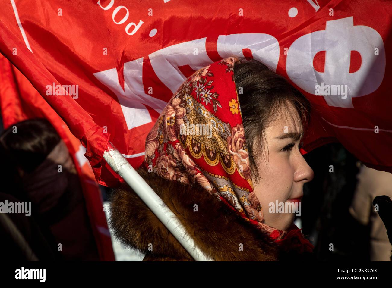 Moscow, Russia. 23rd of February, 2023. A young woman holds flag of the ...