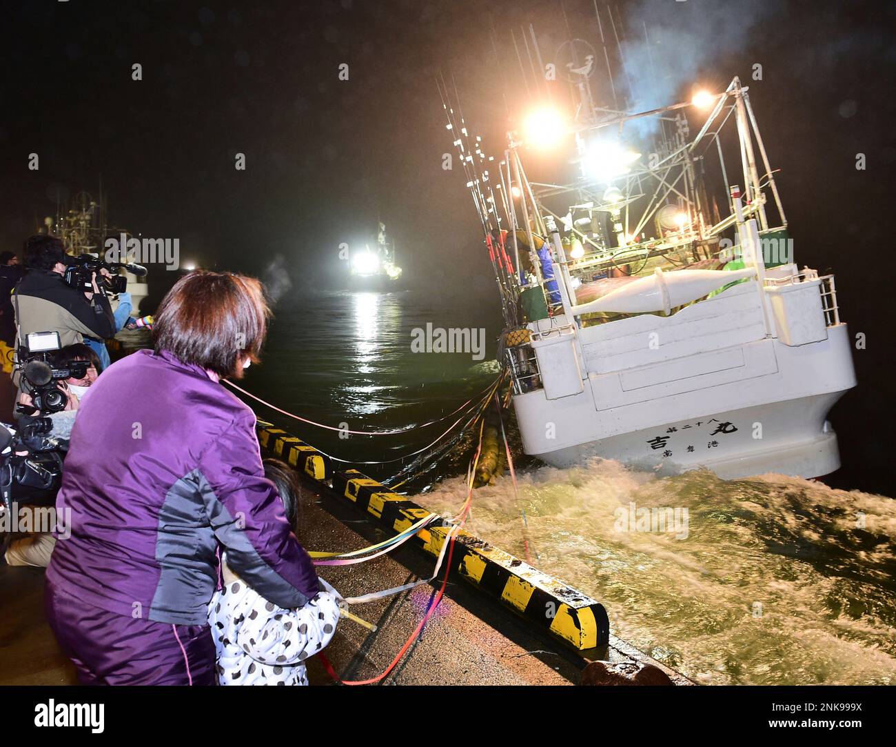 A fishing boat leaves a port to fish at midnight in Nemuro City ...
