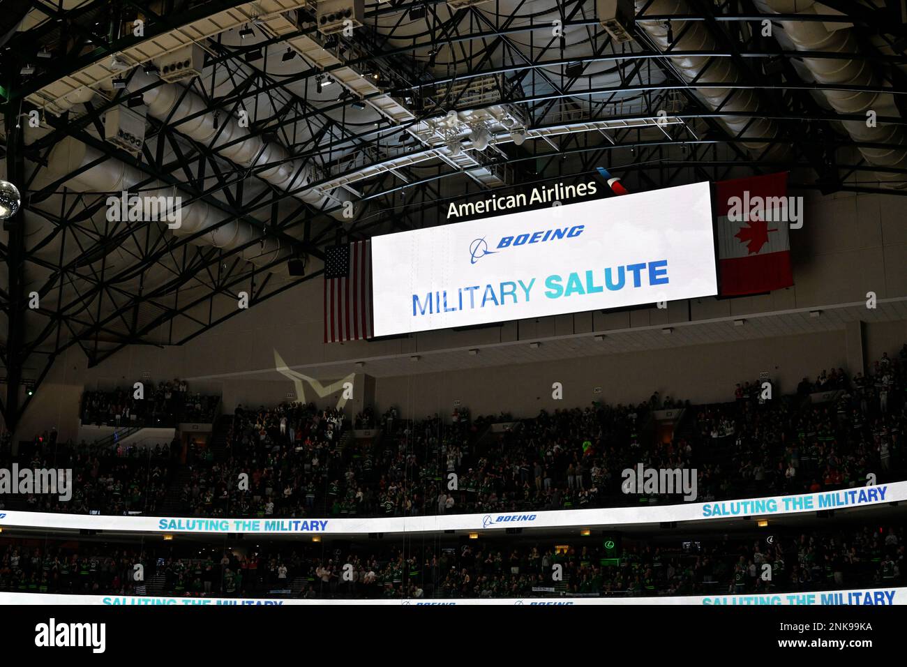 The video board at American Airlines Center displays a military salute ...