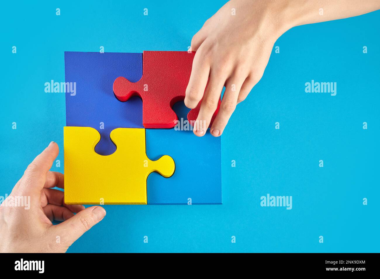 Father and autistic son hands holding jigsaw puzzle shape. World Autism ...