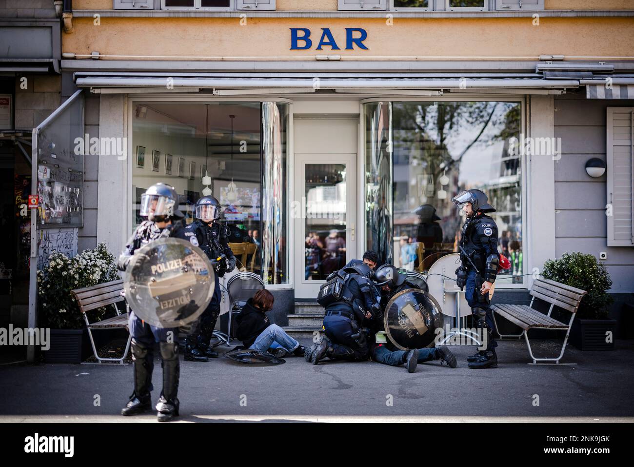 Riot police officers arrest demonstrators during a protest after a May ...