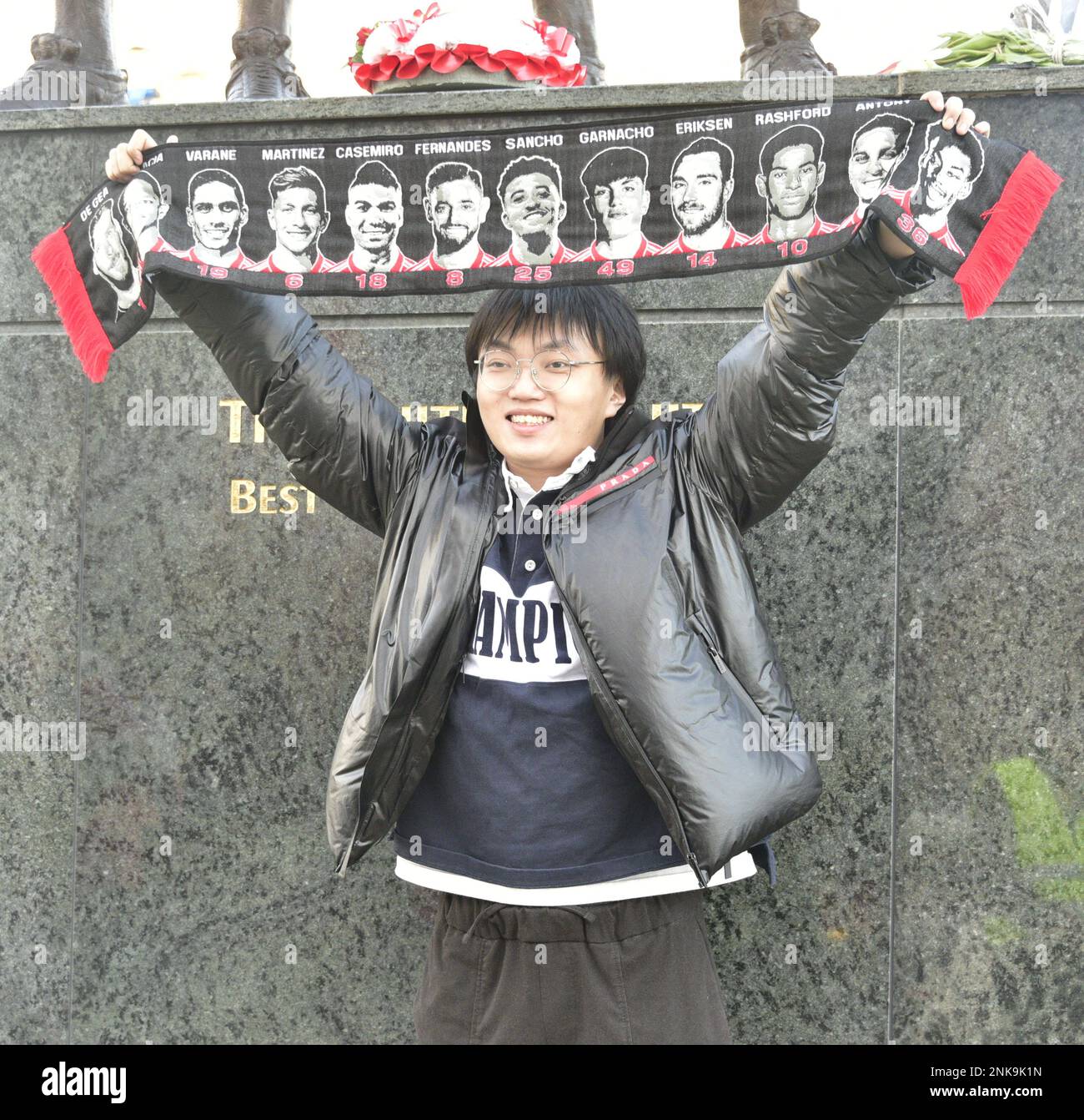 Manchester, UK, 23rd February, 2023. A football fan holds a MUFC scarf ...