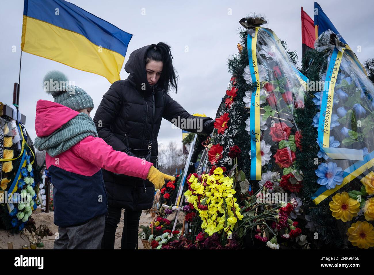 Kyiv, Ukraine - February 22, 2023: A wife and a daughter mourn their ...