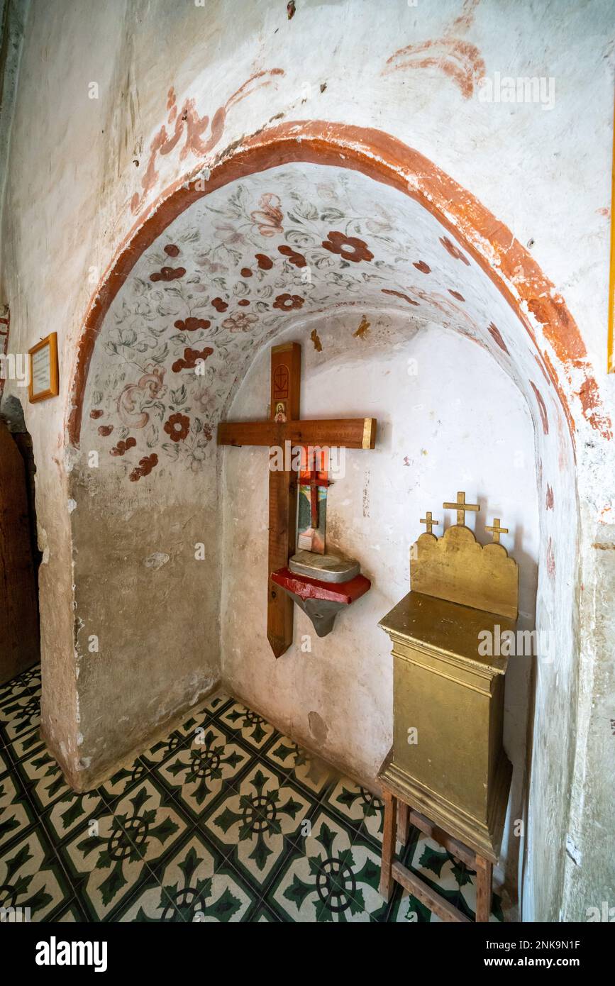 A cross by the holy water stoup in the Spansih colonial Church of San ...