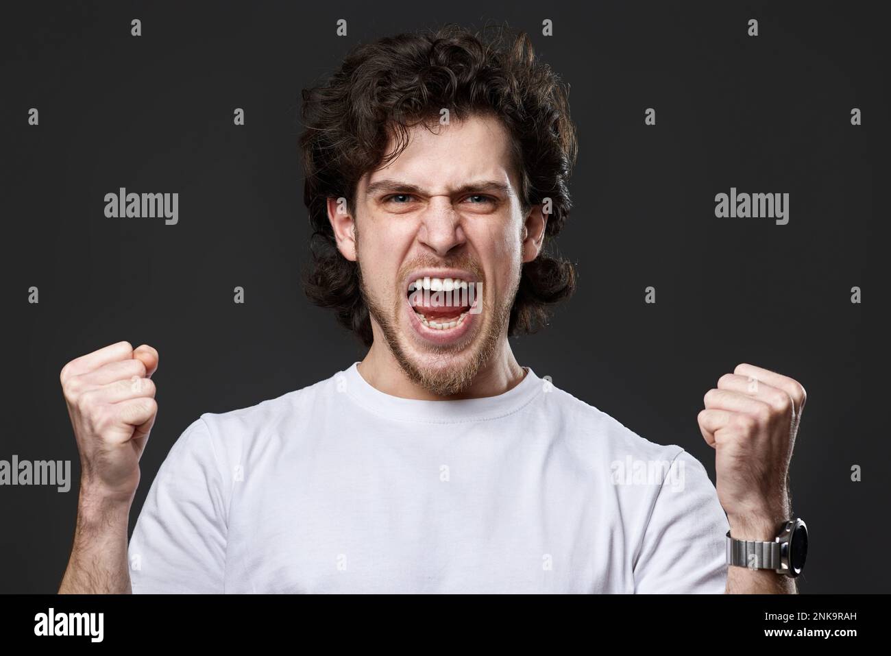 very excited young man showing victory gesture Stock Photo - Alamy